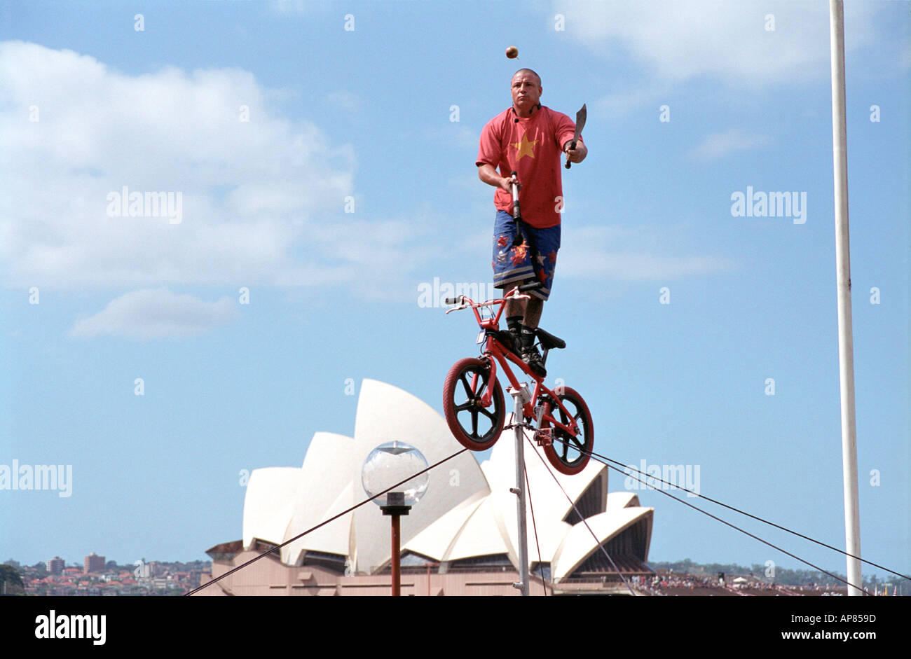 Juggler performing on the Sydney Opera House Stock Photo - Alamy