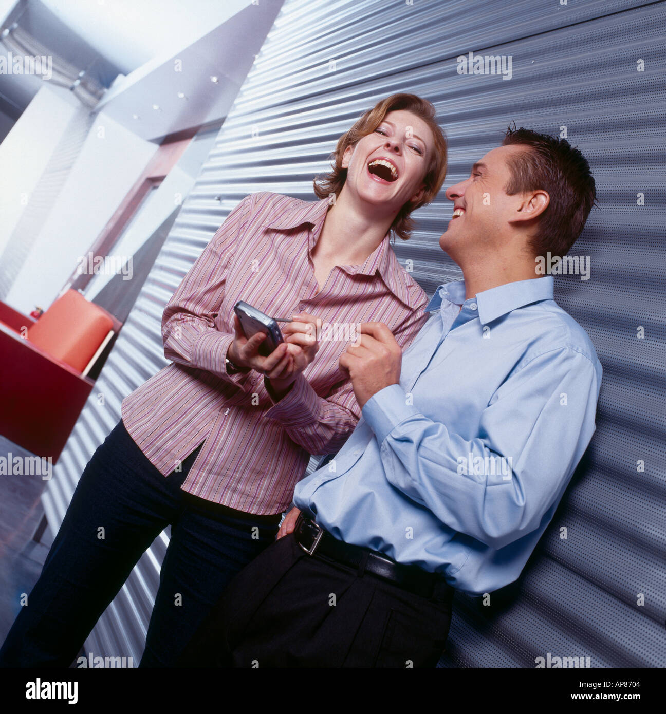 Two employees laughing Stock Photo - Alamy