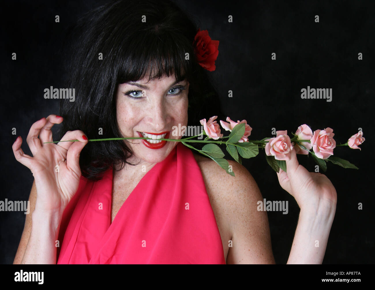 Young woman with rose between teeth hi-res stock photography and images ...