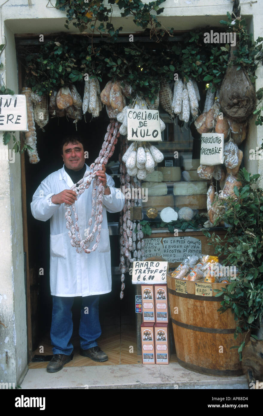 Shopkeeper standing in butcher shop, Norcia, Umbria, Italy Stock Photo ...