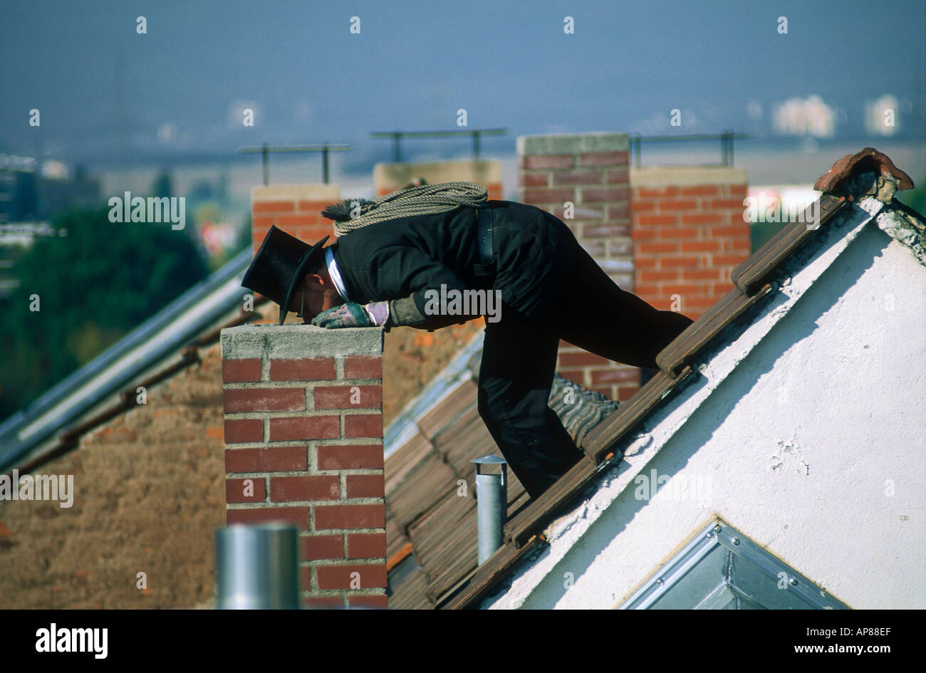 Side profile of man cleaning chimney Stock Photo - Alamy