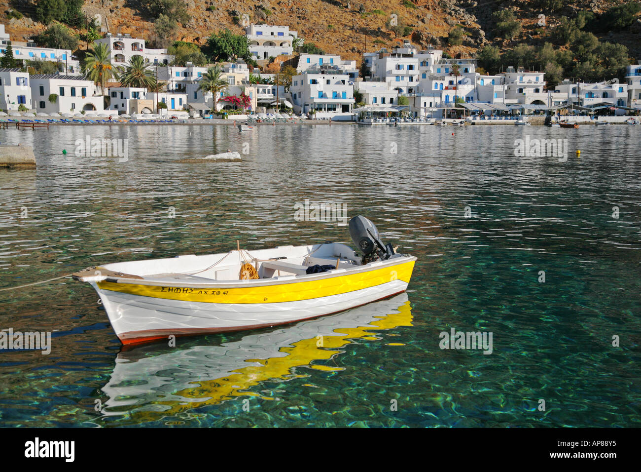 Yellow boat floating in the harbour at Loutro South West Crete Stock ...