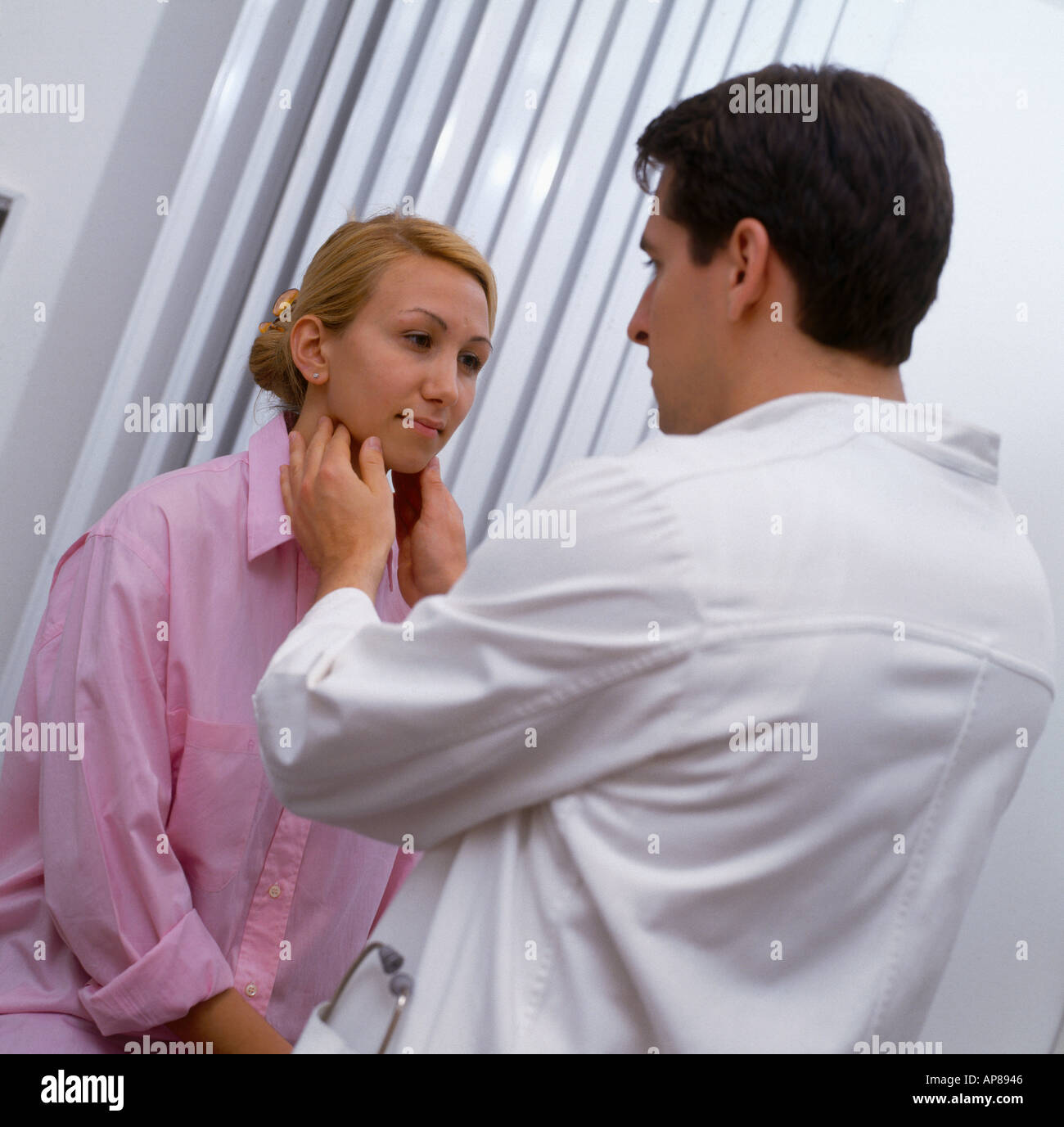 Male doctor examining patient Stock Photo - Alamy