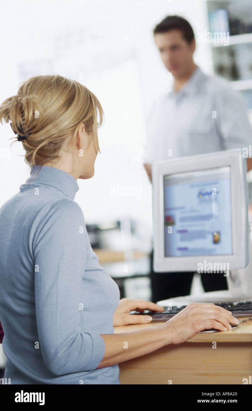 blonde woman woking with a computer back view Stock Photo - Alamy
