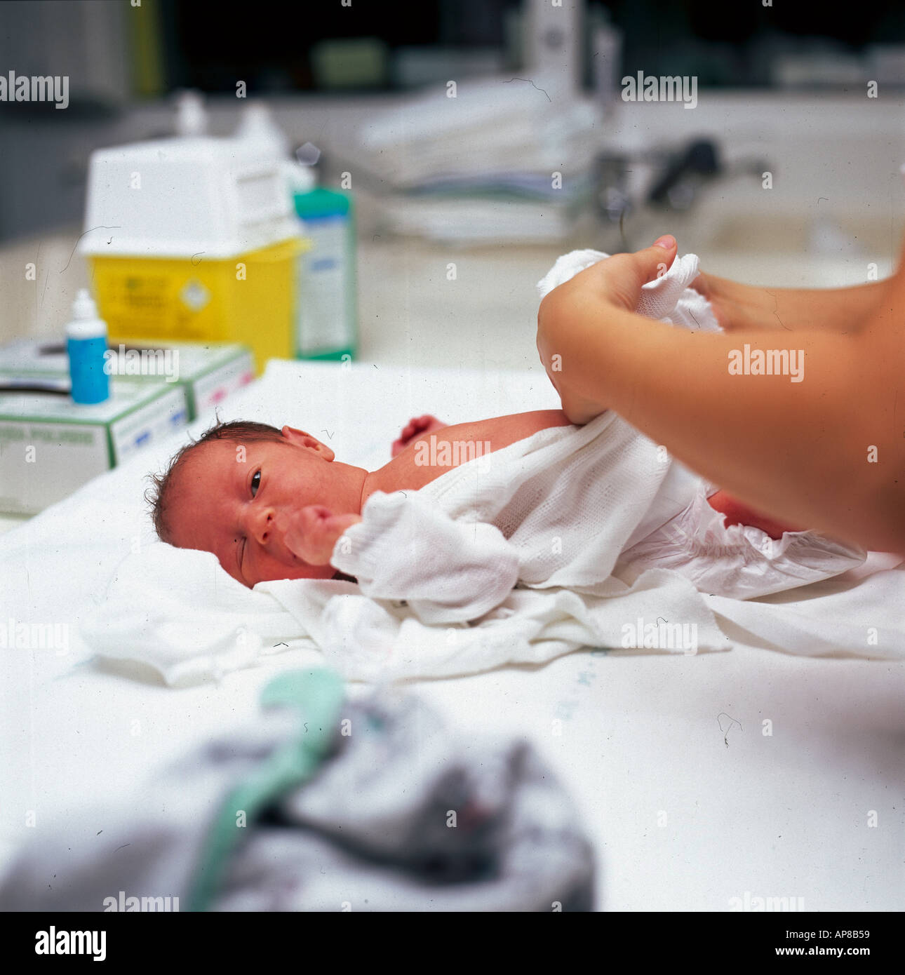 Nurse caring for a newborn baby on a hospital bed Stock Photo - Alamy