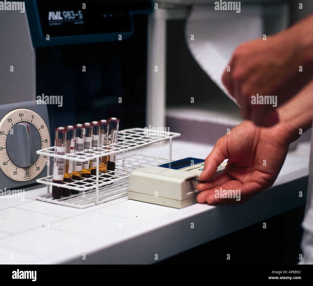 Doctor's hands testing blood with medical equipment in laboratory Stock ...