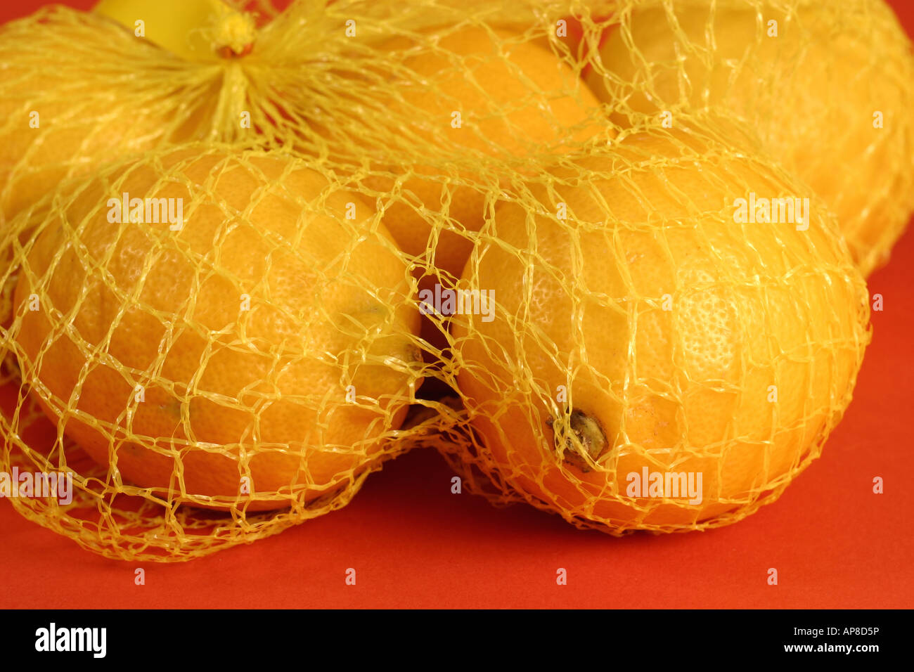 unwaxed lemons in a net Stock Photo - Alamy