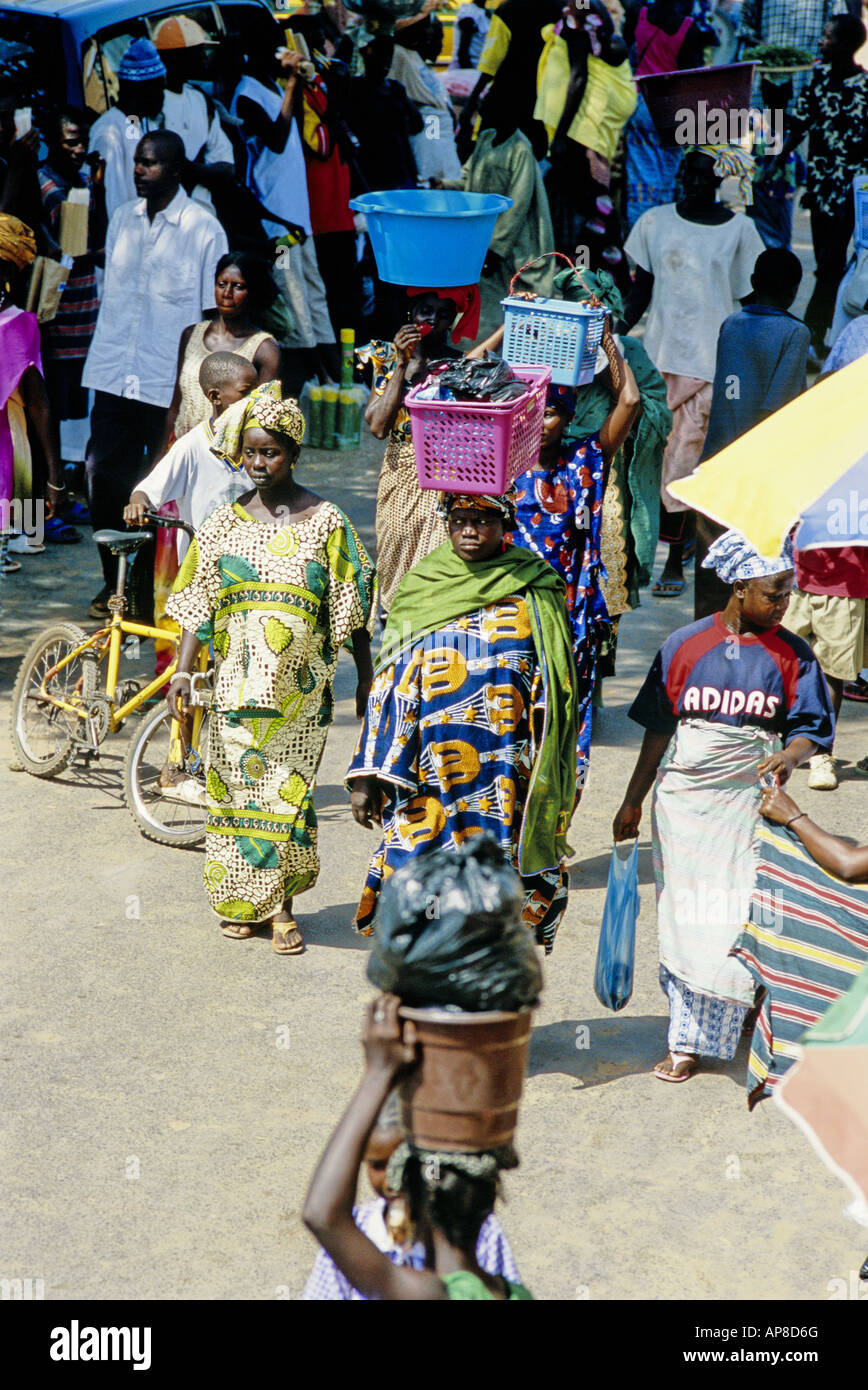African women carry loads on their heads along one of the main shopping ...