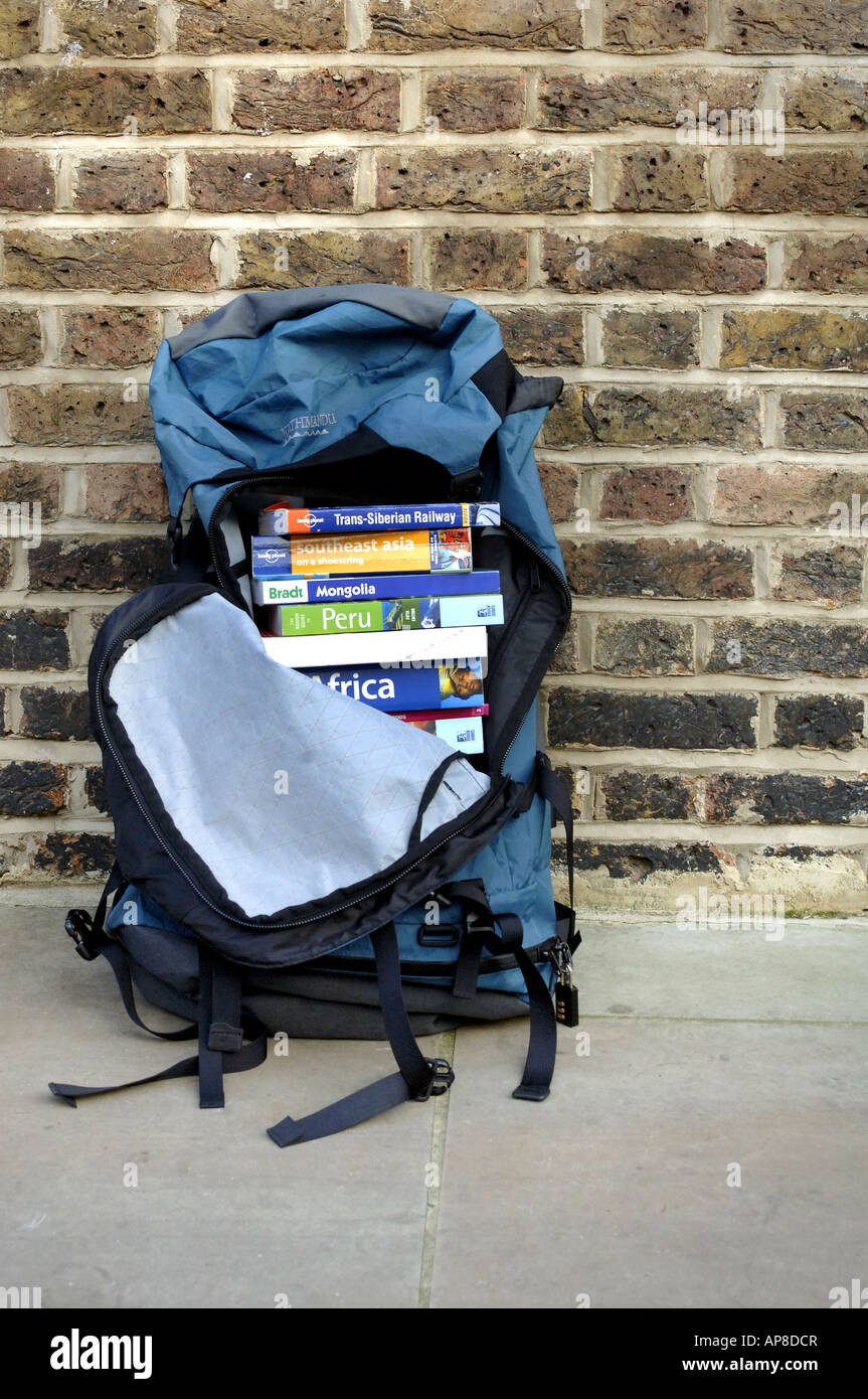 Backpacker going on a big trip backpacking with guide books Stock Photo ...