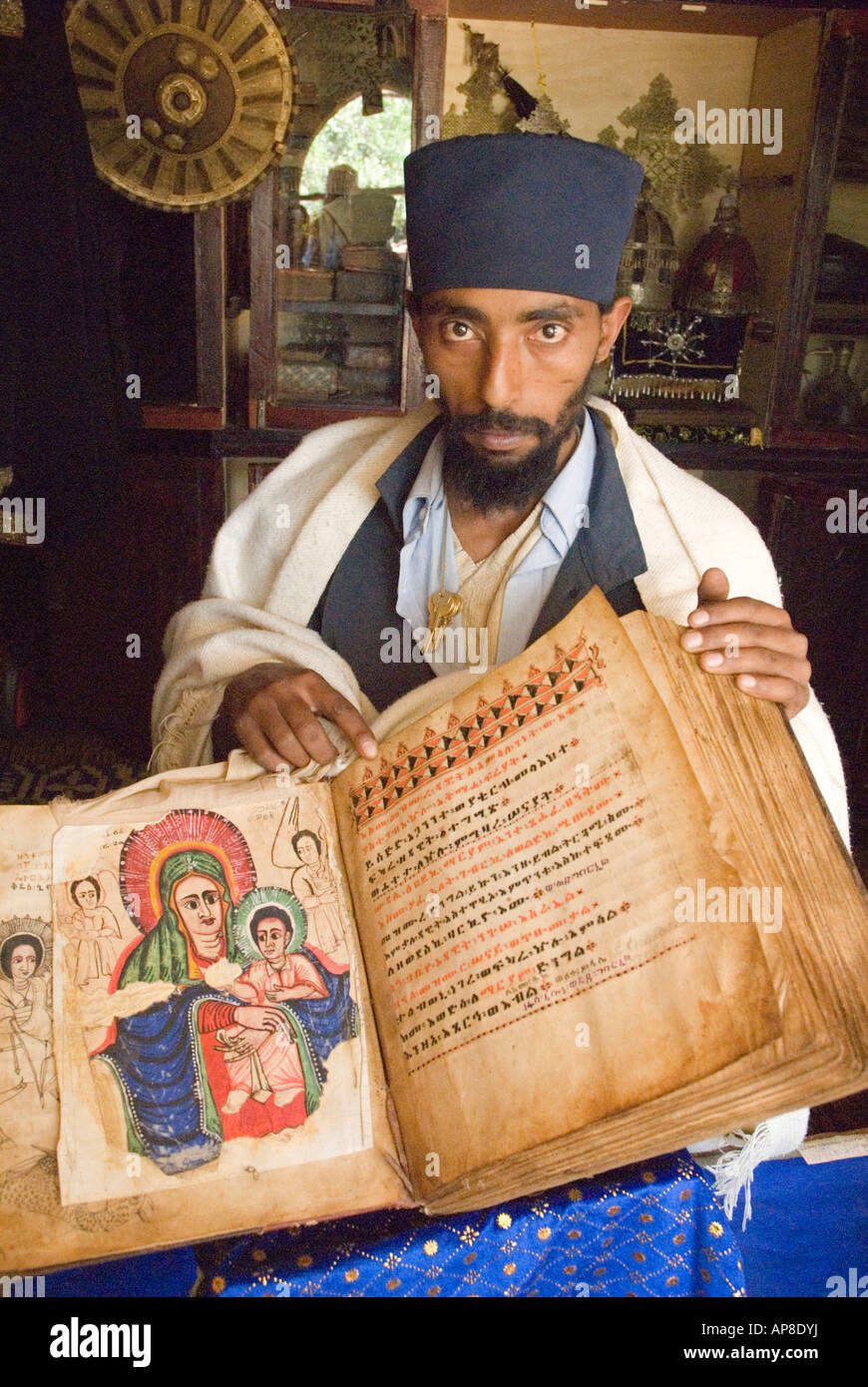 Monk with an ancient bible manuscript in a monastery museum, Zege ...