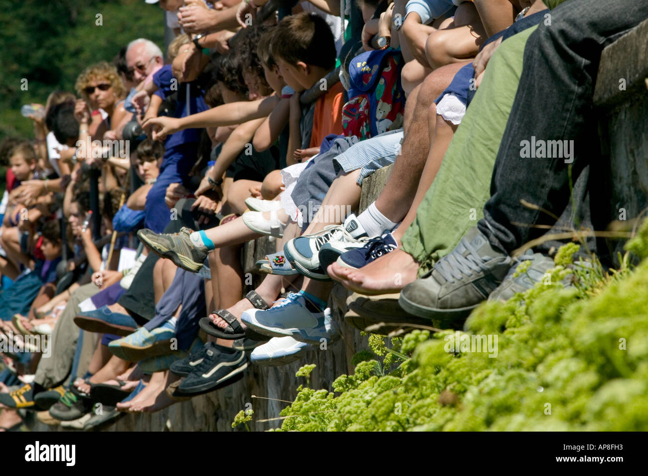 The legs and feet of Basque people watching Sokamuturra sitting on ...