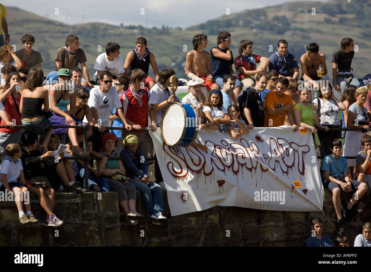 Crowds of Basque people watch Sokamuturra bull running event sitting on ...