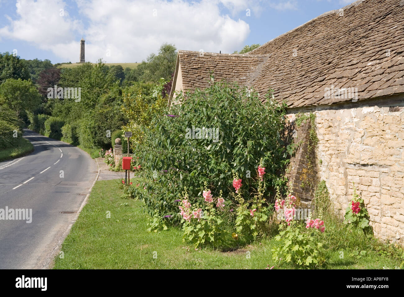 An old Cotswold barn at Southend Farm, with Tyndales Monument in the ...