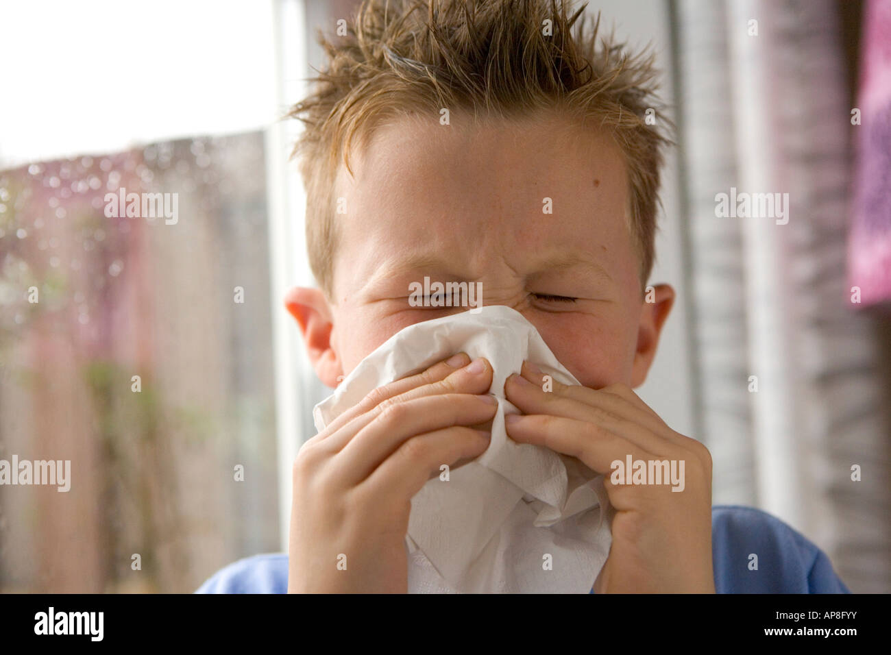 Boy sneezing in handkerchief hi-res stock photography and images - Alamy
