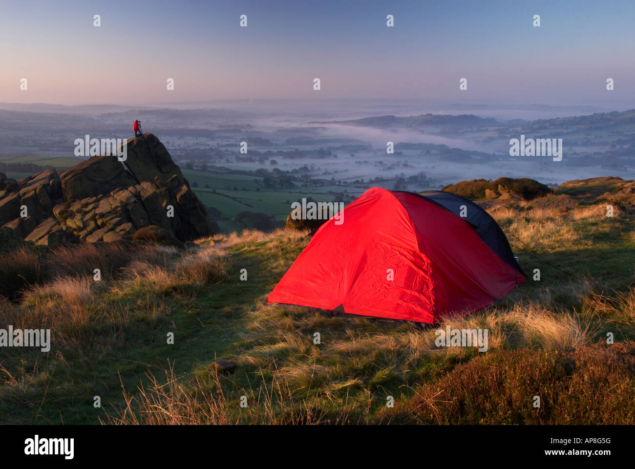 A Climber Wearing Red Coat With Red Tent At The Roaches Staffordshire ...