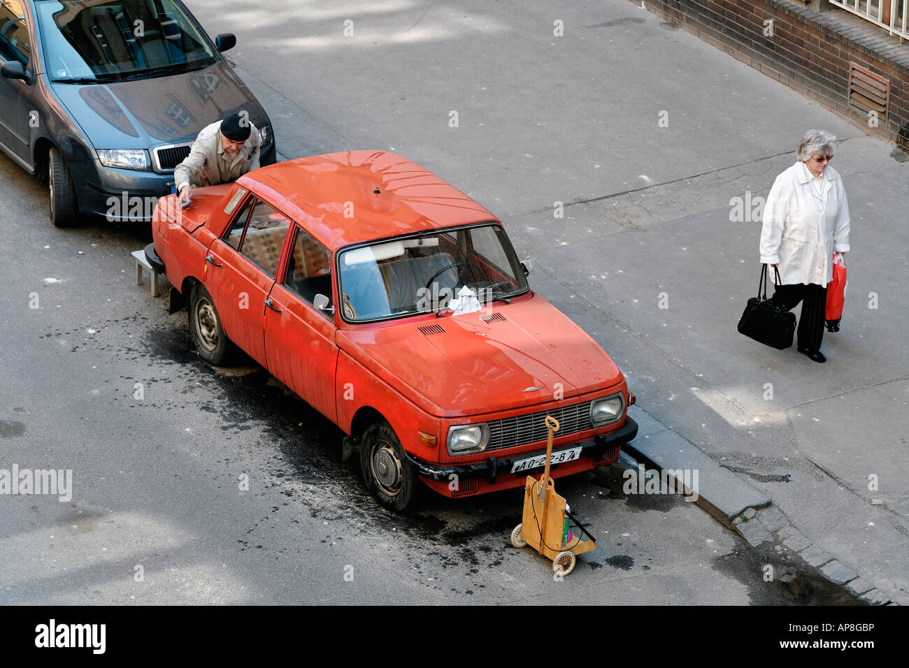 OLD MAN WASHING OLD EAST GERMAN CAR WARTBURG ON THE STREET Stock Photo ...