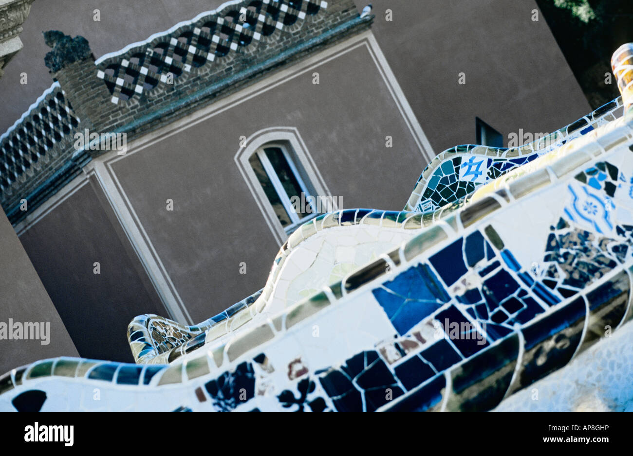 Gaudi building behind the serpentine benches in Parc Guell, Barcelona ...