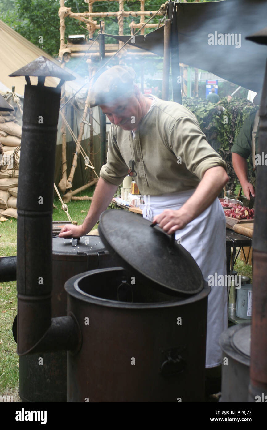 British World War Two re enactor preparing food in the kitchen at an ...