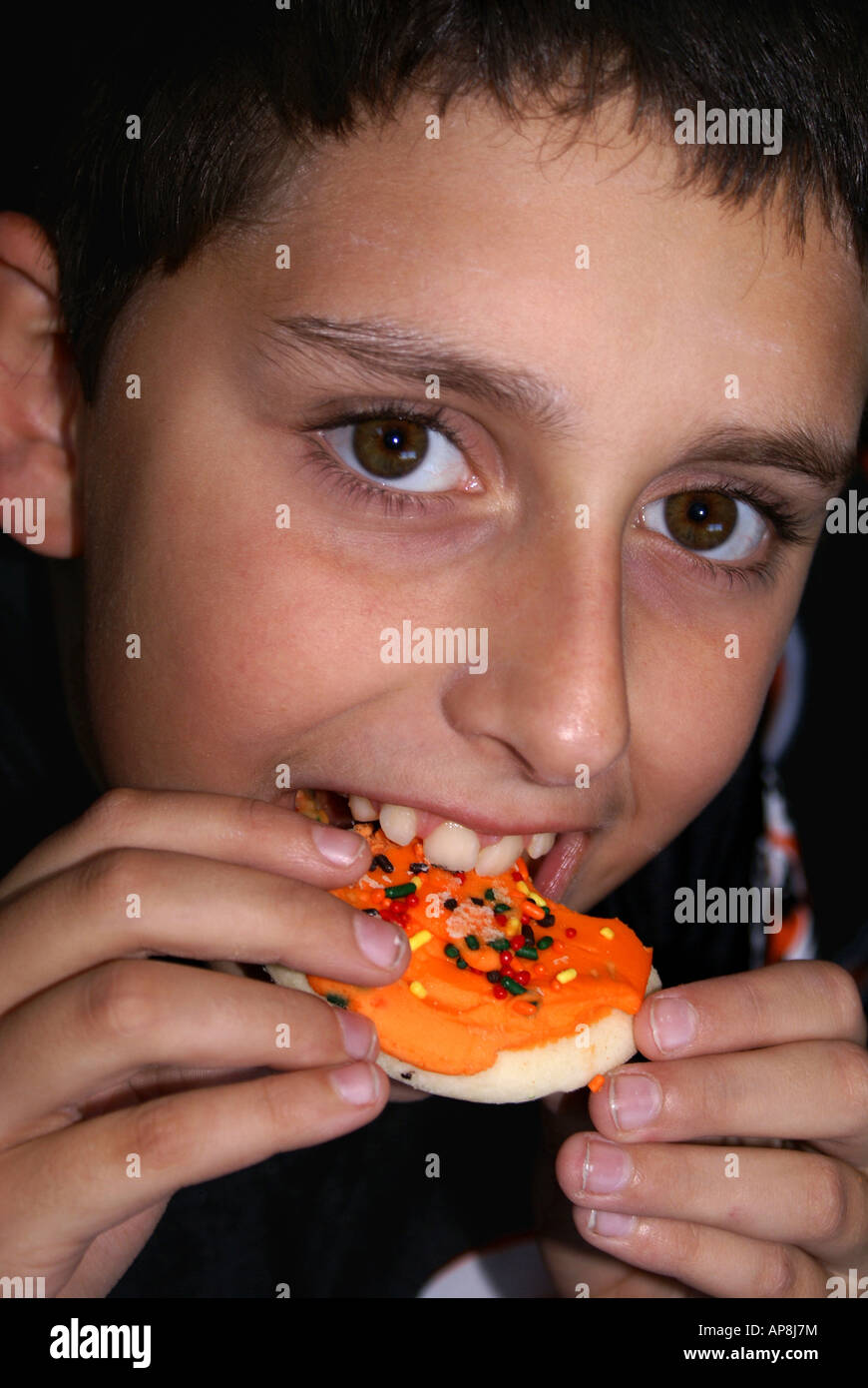 Biting into a cookie Stock Photo - Alamy