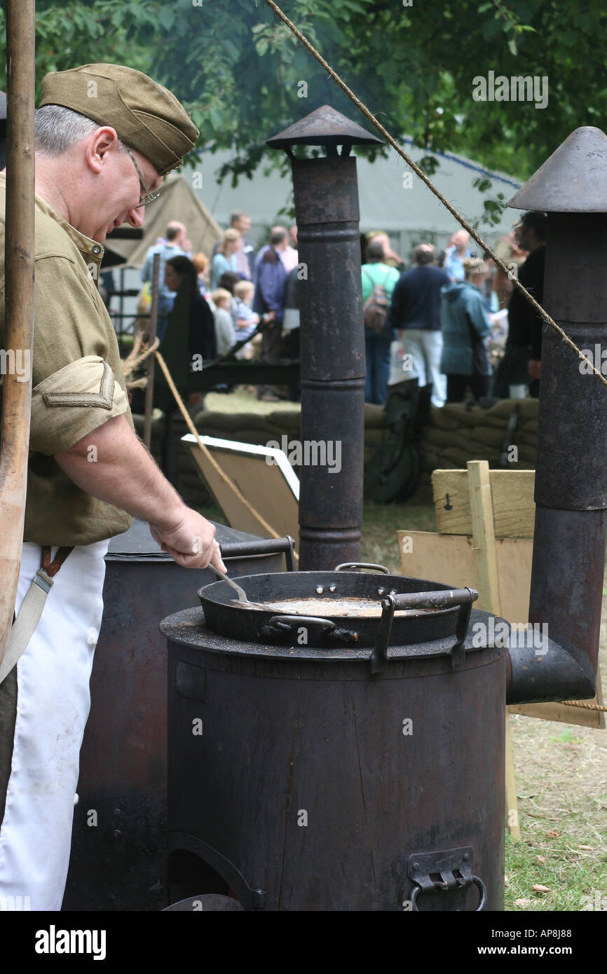 British World War Two re enactor preparing food in the kitchen at an ...
