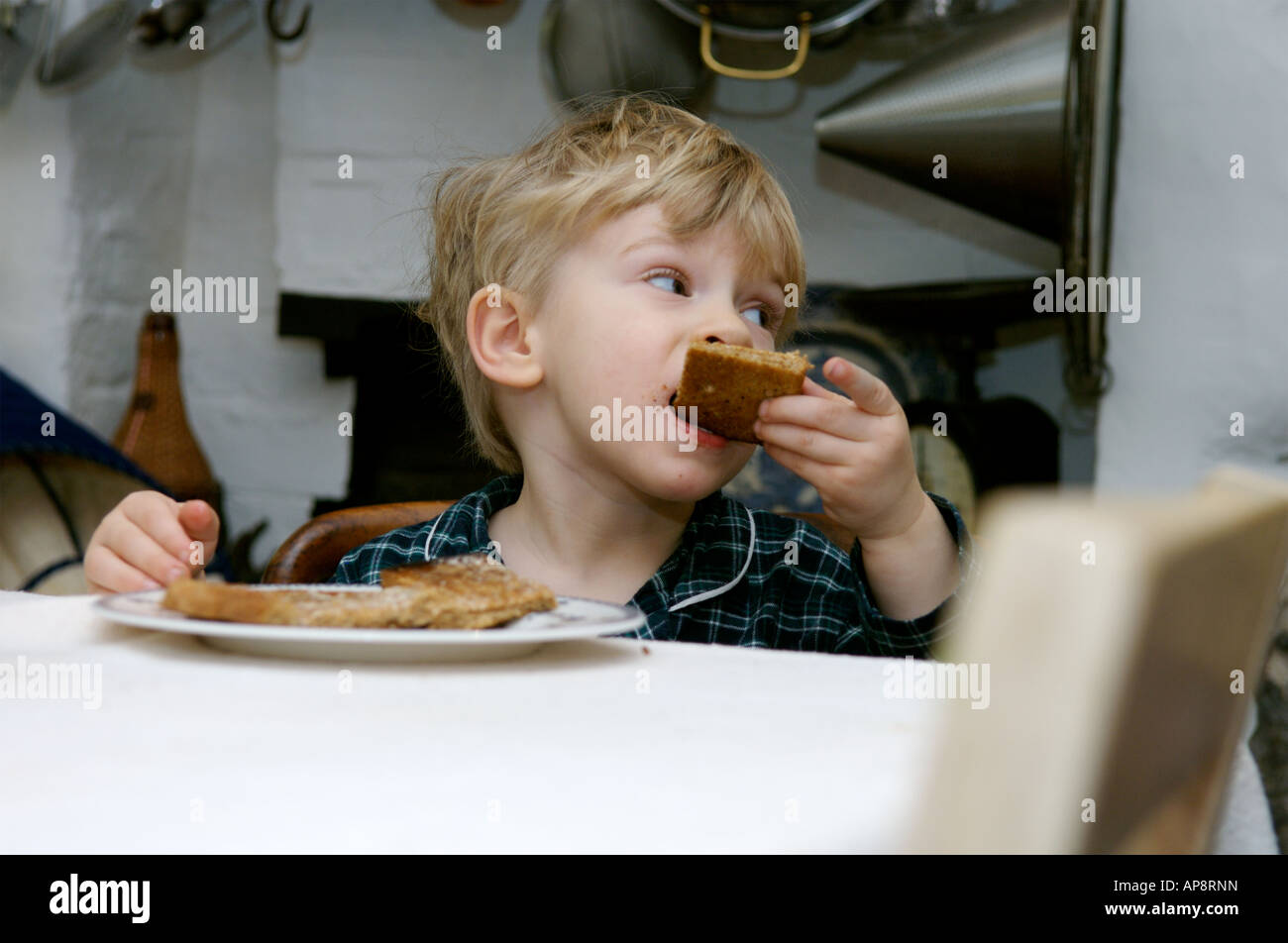 A young boy eating breakfast Stock Photo - Alamy