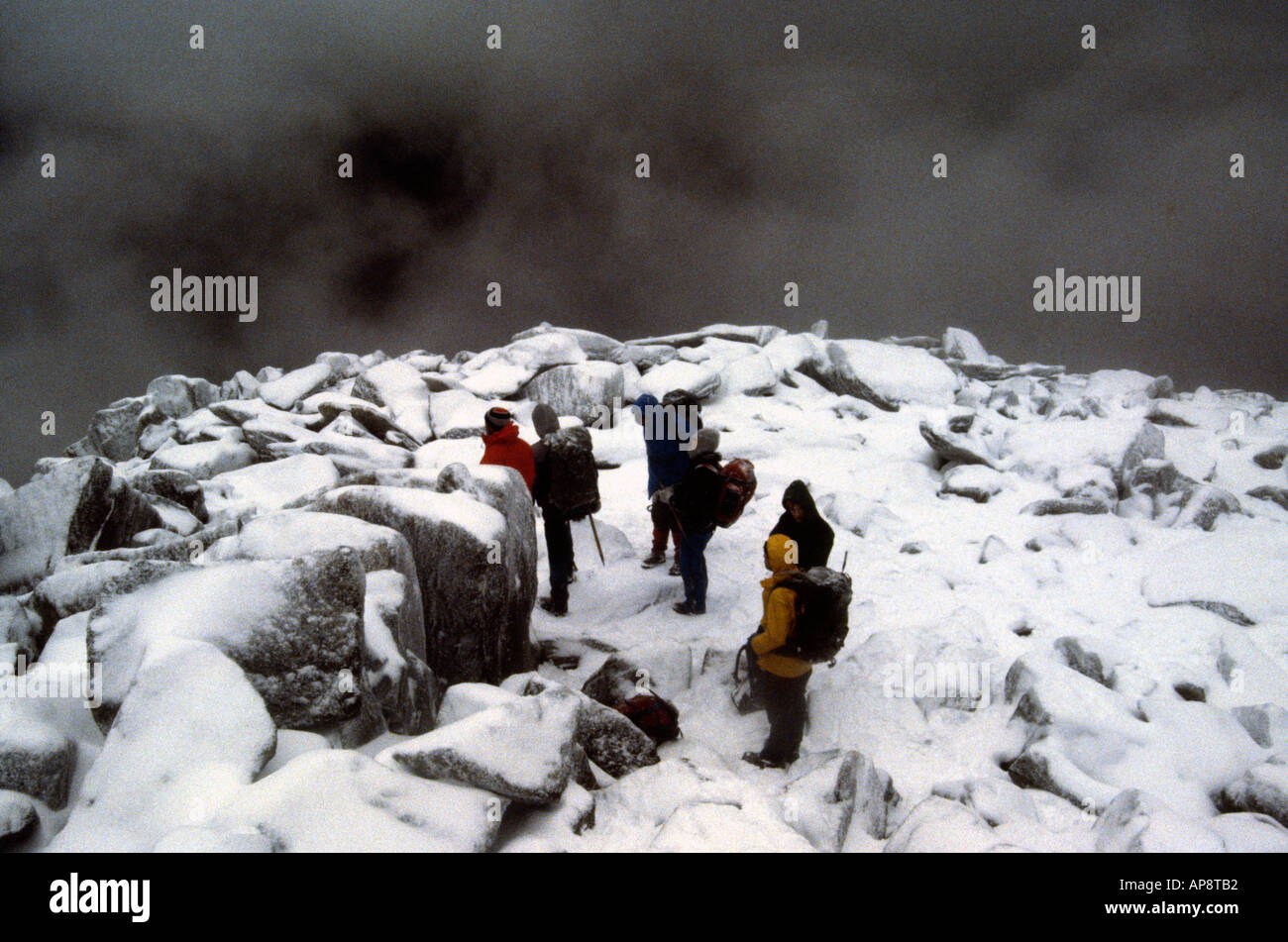 Mountaineers on the snow covered summit of Tryfan in Snowdonia National ...
