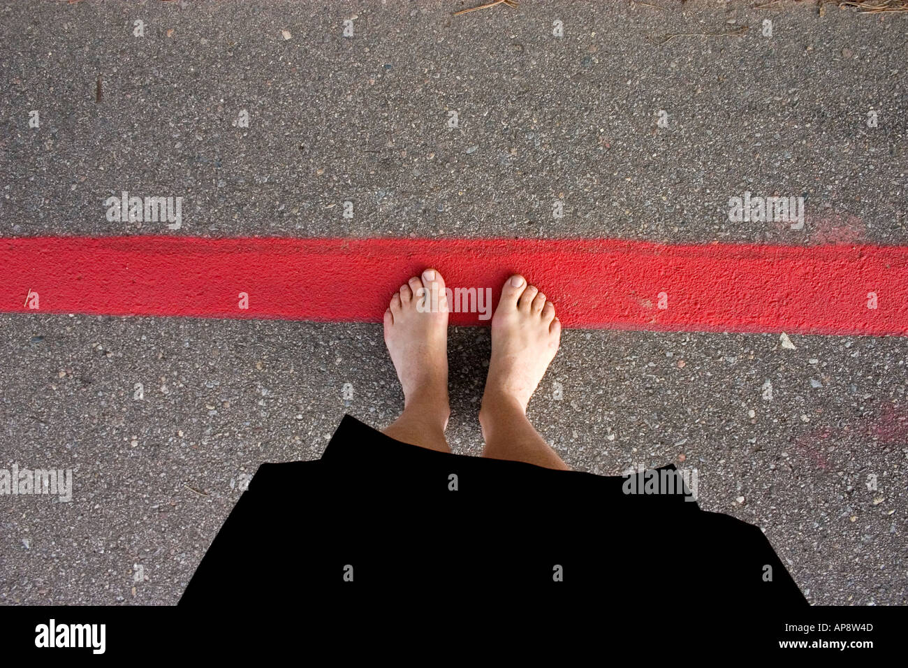 womans feet standing on red line Stock Photo - Alamy