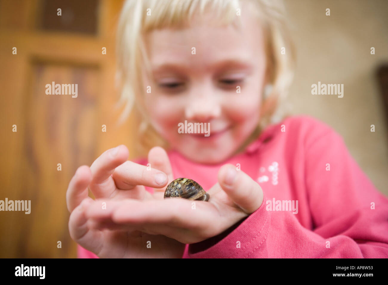 girl holding snail Stock Photo - Alamy