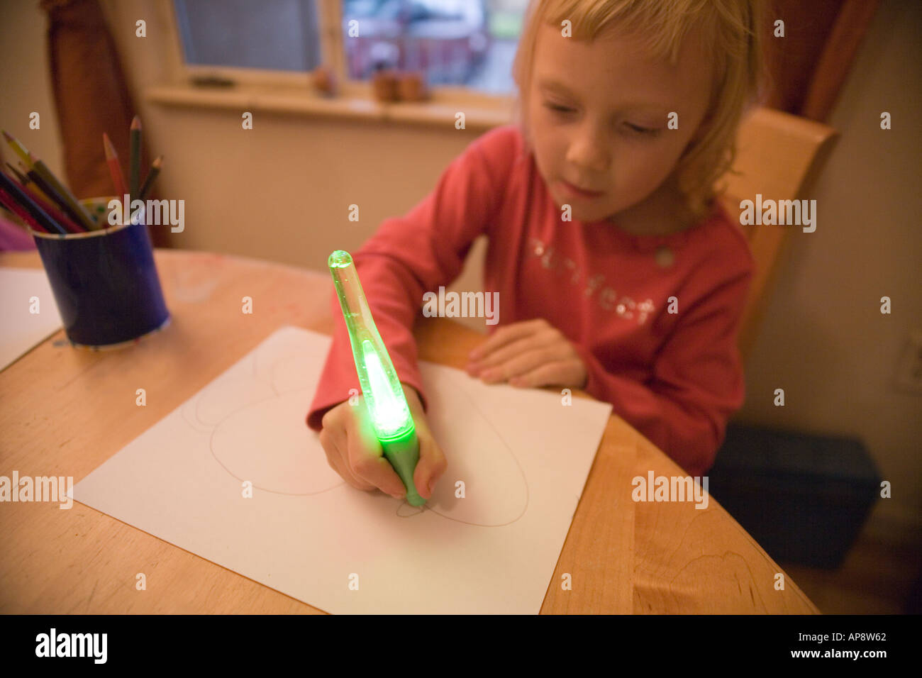 girl writing with glow pen at home Stock Photo - Alamy