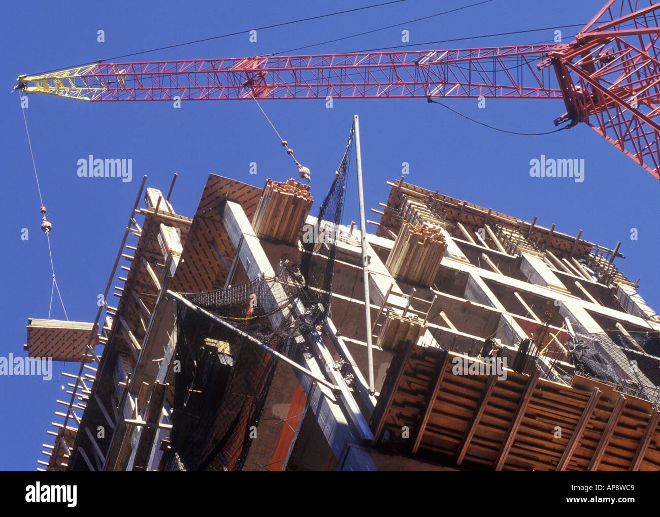 USA New York City commercial building construction site crane lifting ...