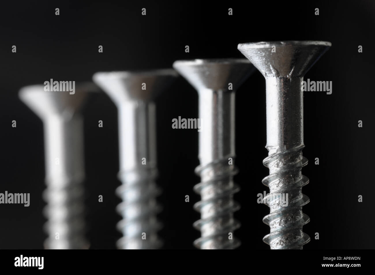 Four screws at various heights Stock Photo - Alamy