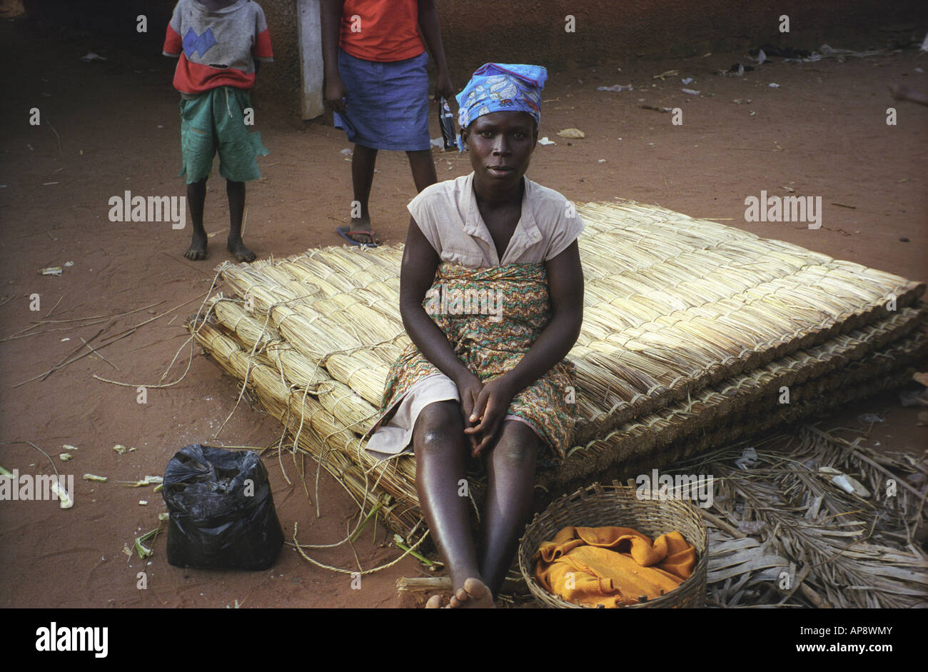 Handsome black African woman sitting on mattresses offered for sale at ...