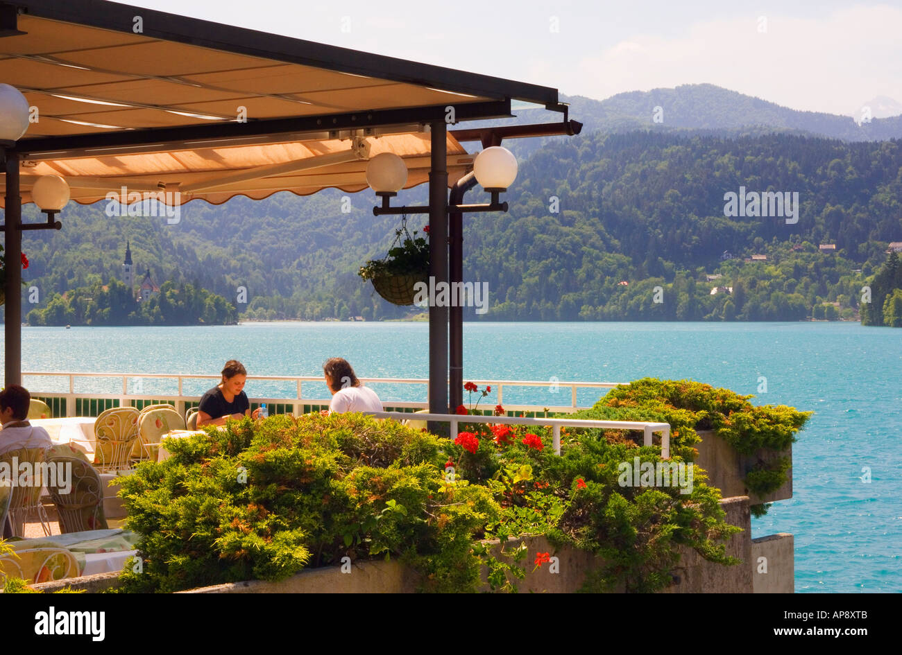 Waterfront restaurant at Lake Bled Slovenia with the island chapel of ...