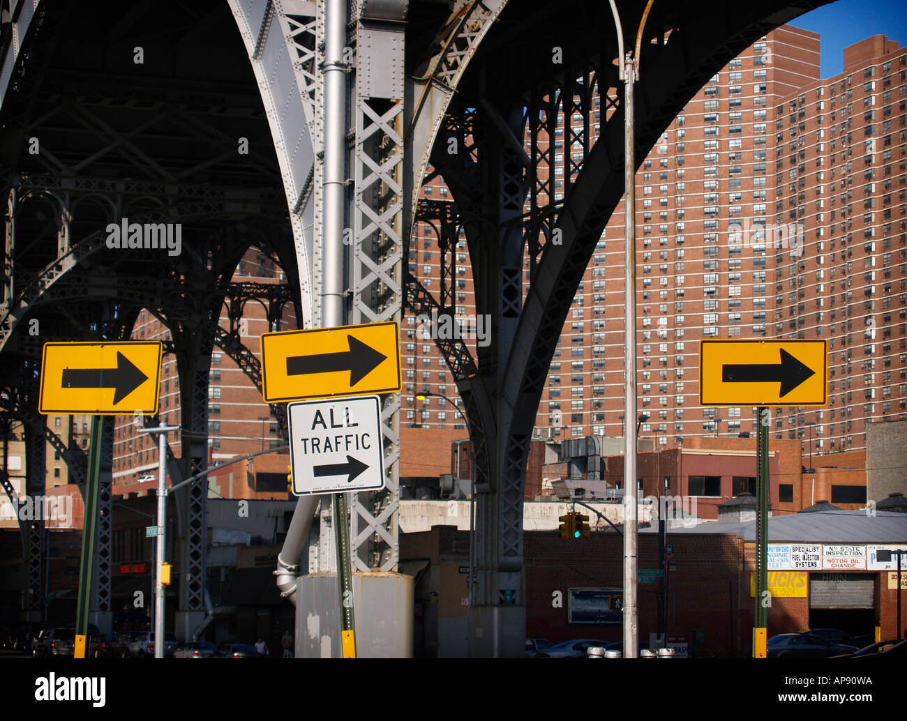 One-way sign and yellow directional arrow signs at an intersection in ...