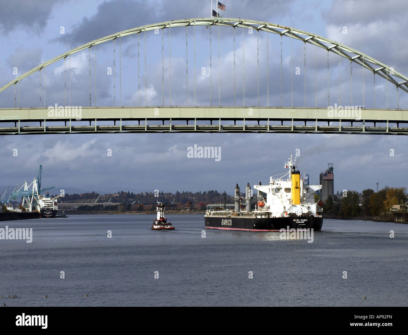 A cargo ship passing under the Fremont Bridge in Portland, Oregon, USA ...