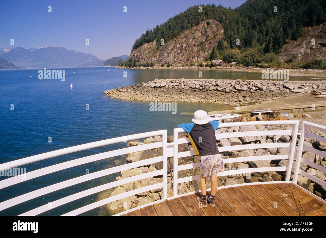 Young boy standing on pier lookout Porteau Cove Marine Park Howe Sound ...