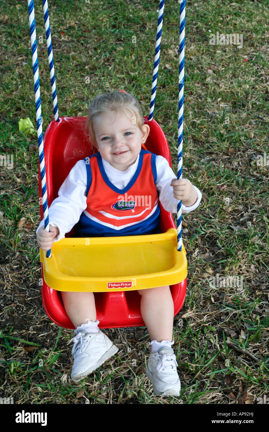 Small Toddler Girl in a Swing Stock Photo - Alamy