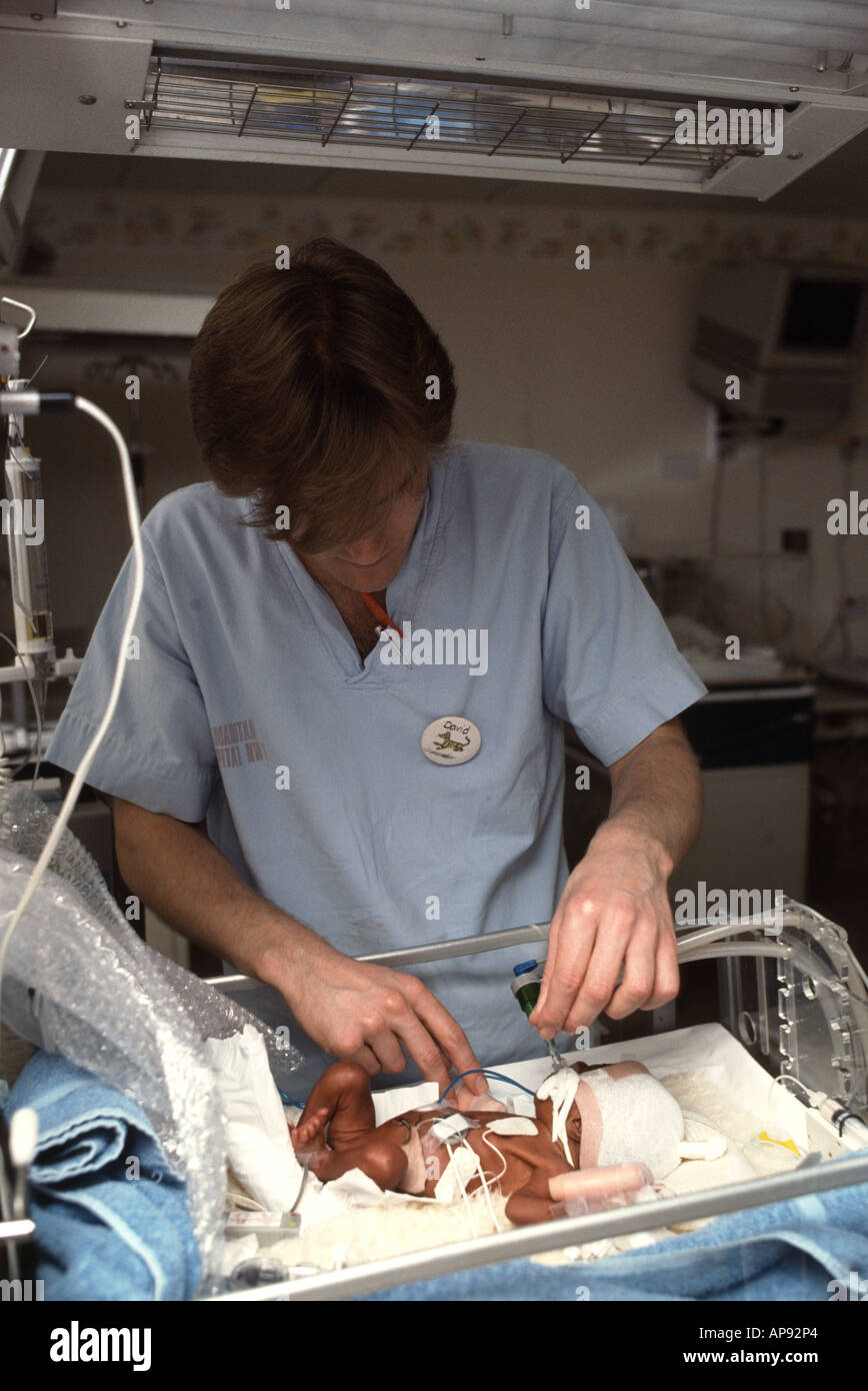 male nurse tending premature baby in neonatal unit Stock Photo - Alamy