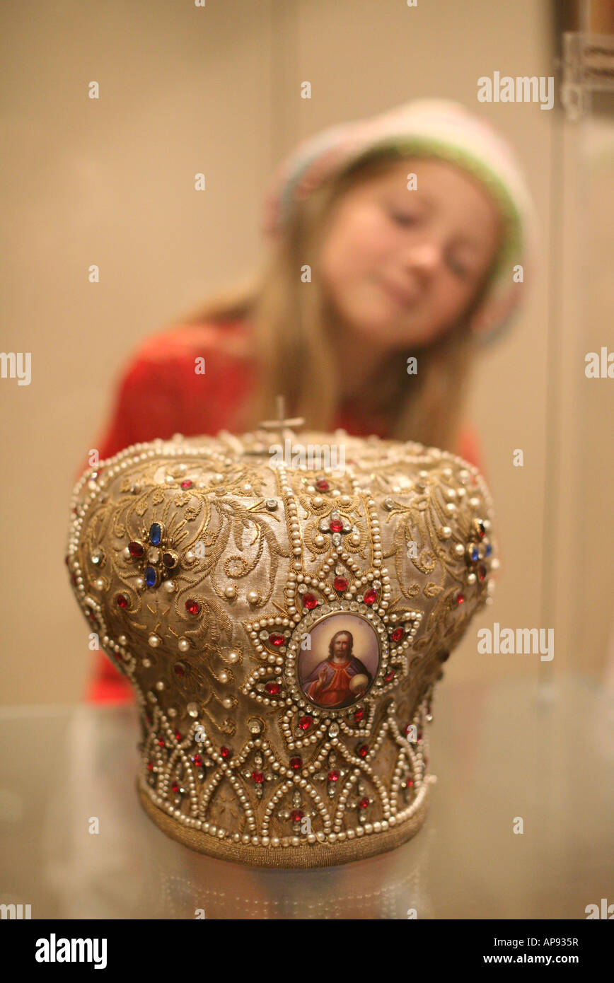 Young Russian pilgrim looking at the miter in the Treasury Museum of ...
