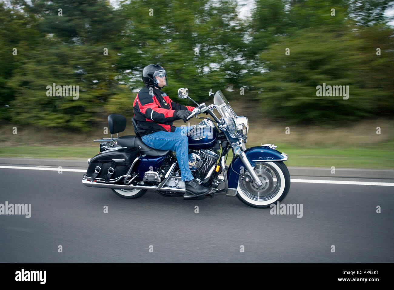 MIDDLE AGED MAN RIDING A HARLEY DAVIDSON MOTORBIKE WITH BLURRED ...