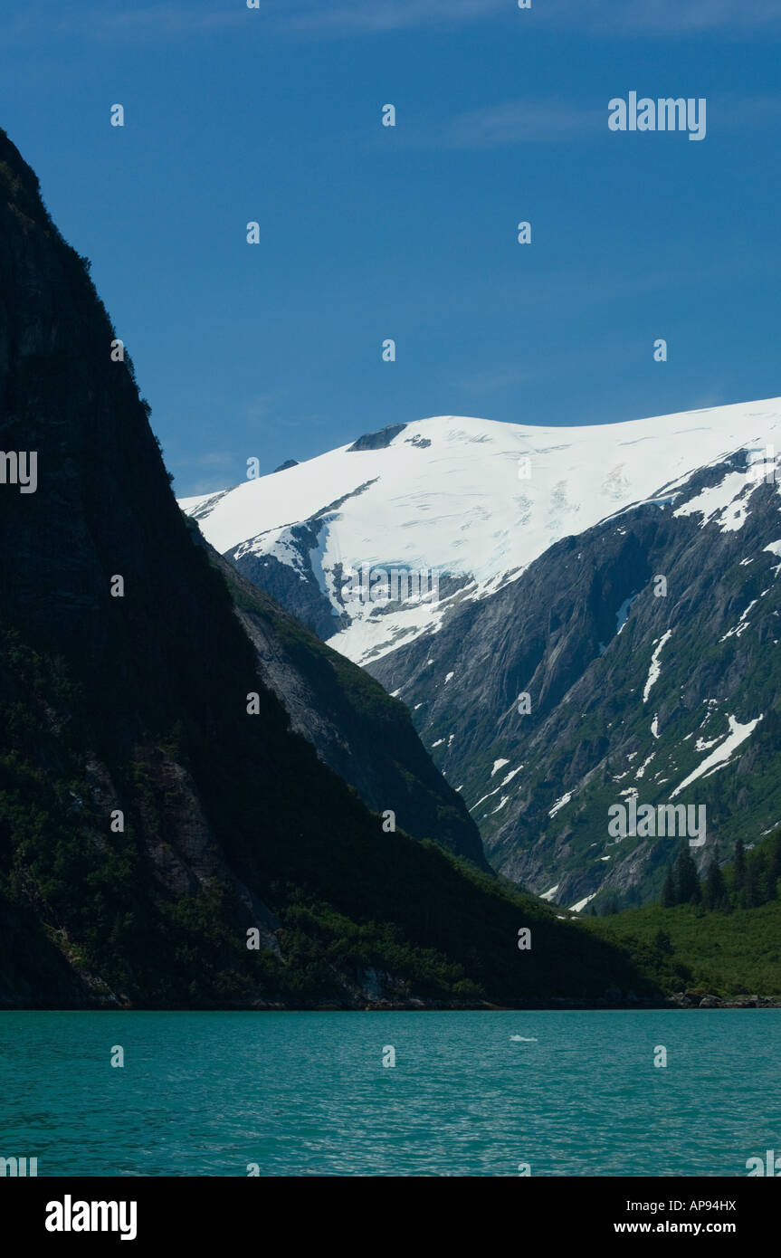 Mountains rise dramatically from waters colored aqua from glacial silt ...