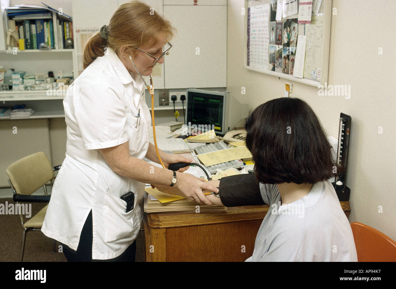 midwife taking blood pressure from pregnant woman Stock Photo - Alamy