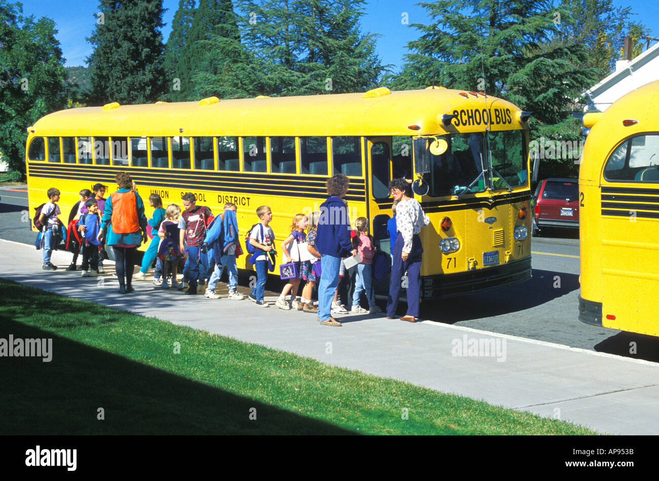 elementary school children boarding school bus after school Mt Shasta ...