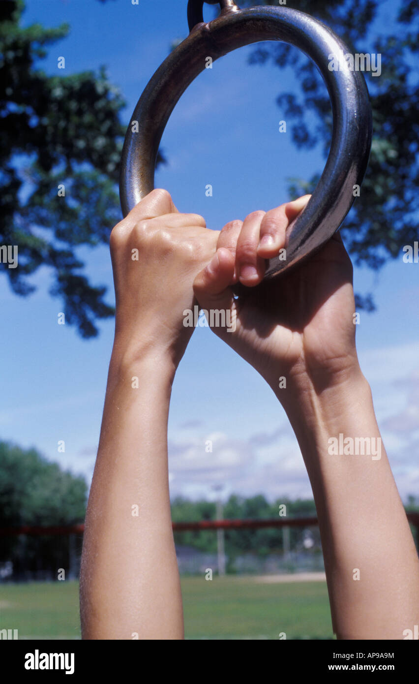 Child hanging on to a ring Stock Photo - Alamy