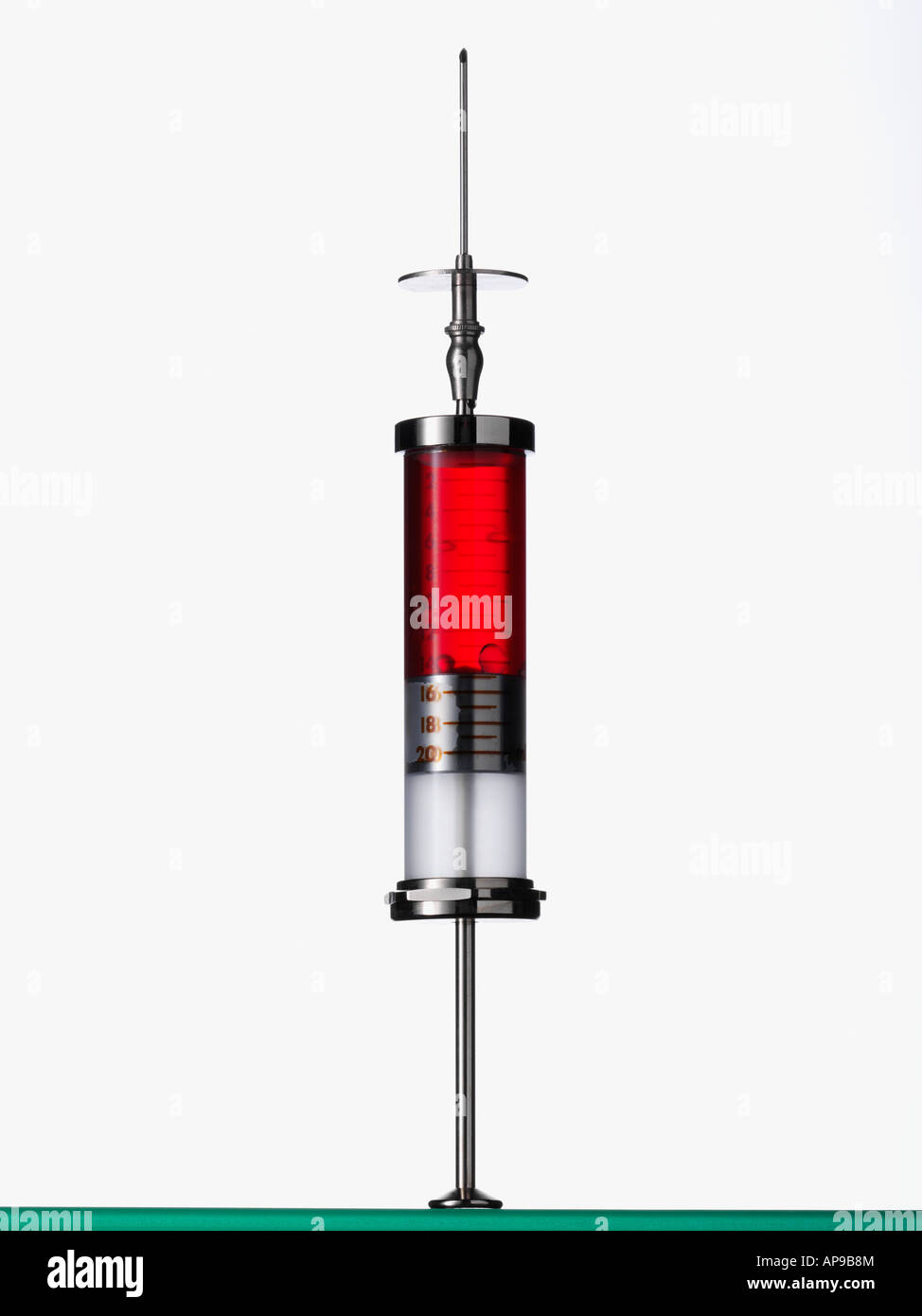 Syringe containing red liquid Stock Photo - Alamy