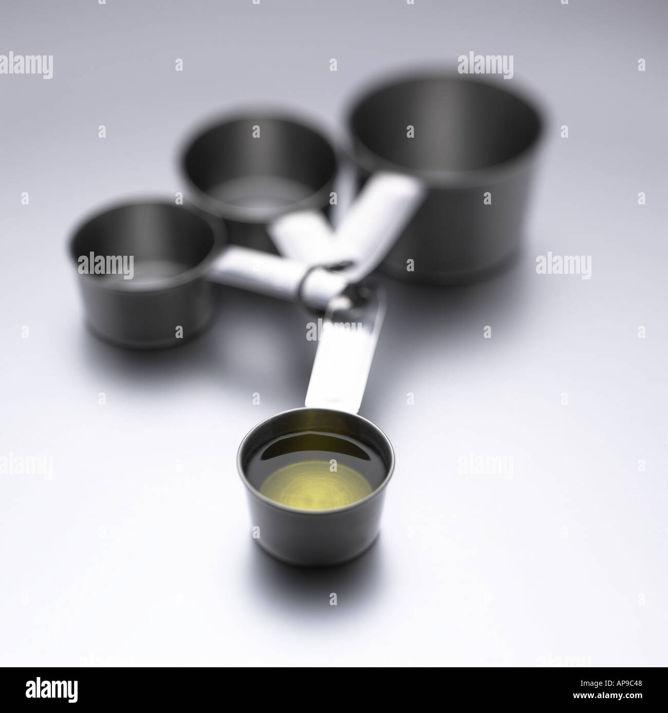 olive oil in a measuring cup with the other sizes fanned out in the ...