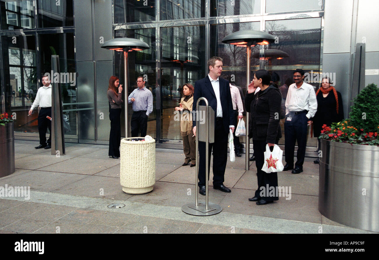 People taking a smoking break outside a building on Canary Wharf London ...