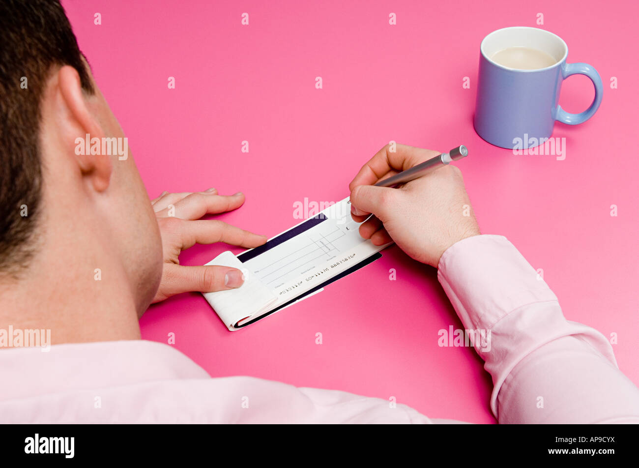 Man signing cheque Stock Photo - Alamy