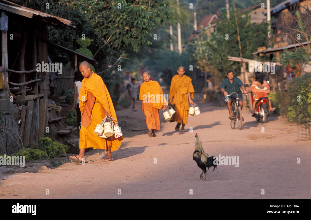 Saffron robed monks about their early morning chores backstreets of ...