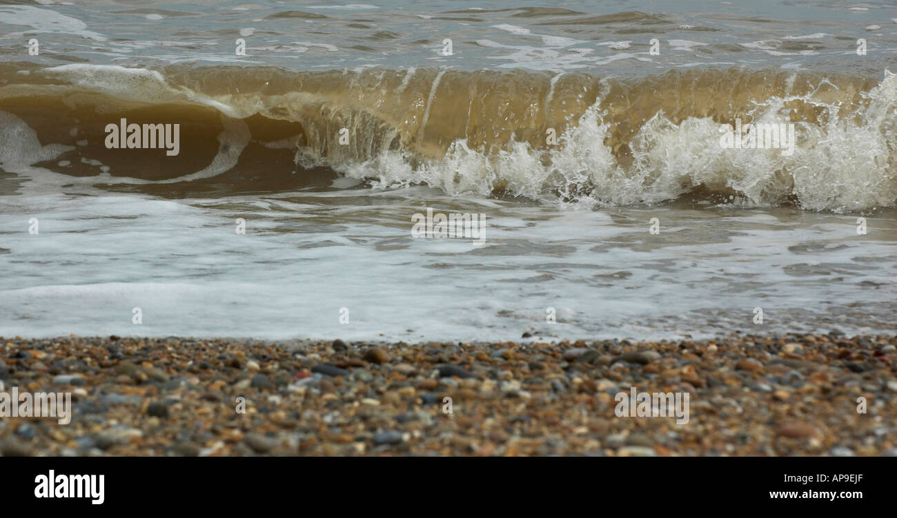 Wave rolling onto pebble beach Stock Photo - Alamy